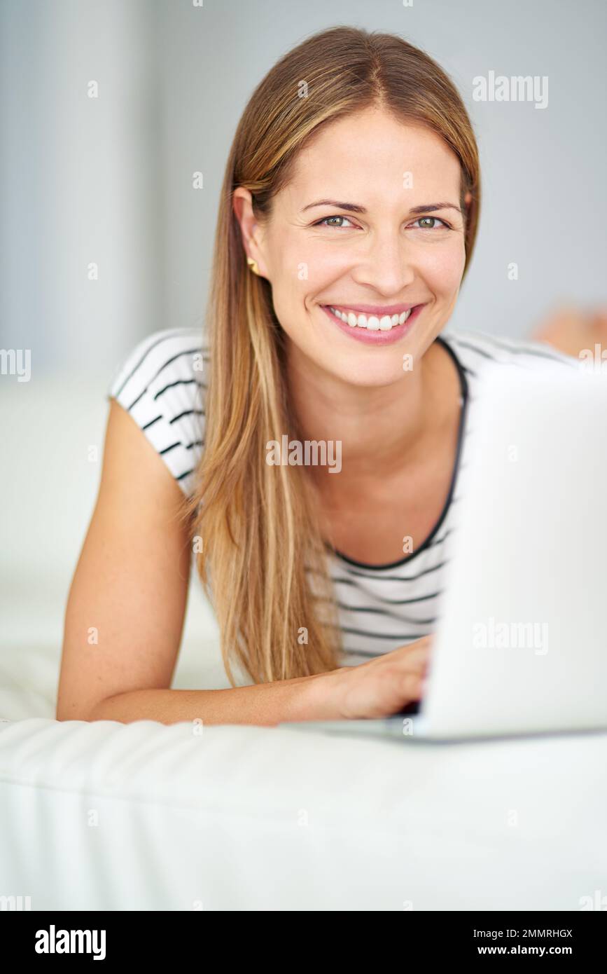 My inbox is empty. a young woman browsing the internet at home Stock ...