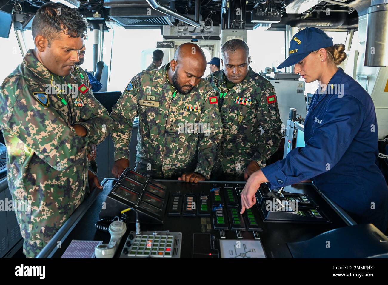 Ens. Allison Ruth explains to several Maldives Coast Guard members how ...