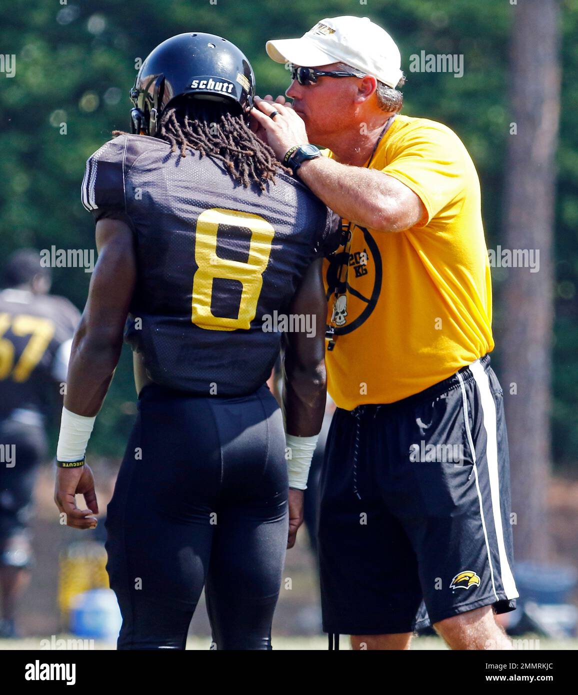 Southern Mississippi football coach Jay Hopson, right, whispers to ...