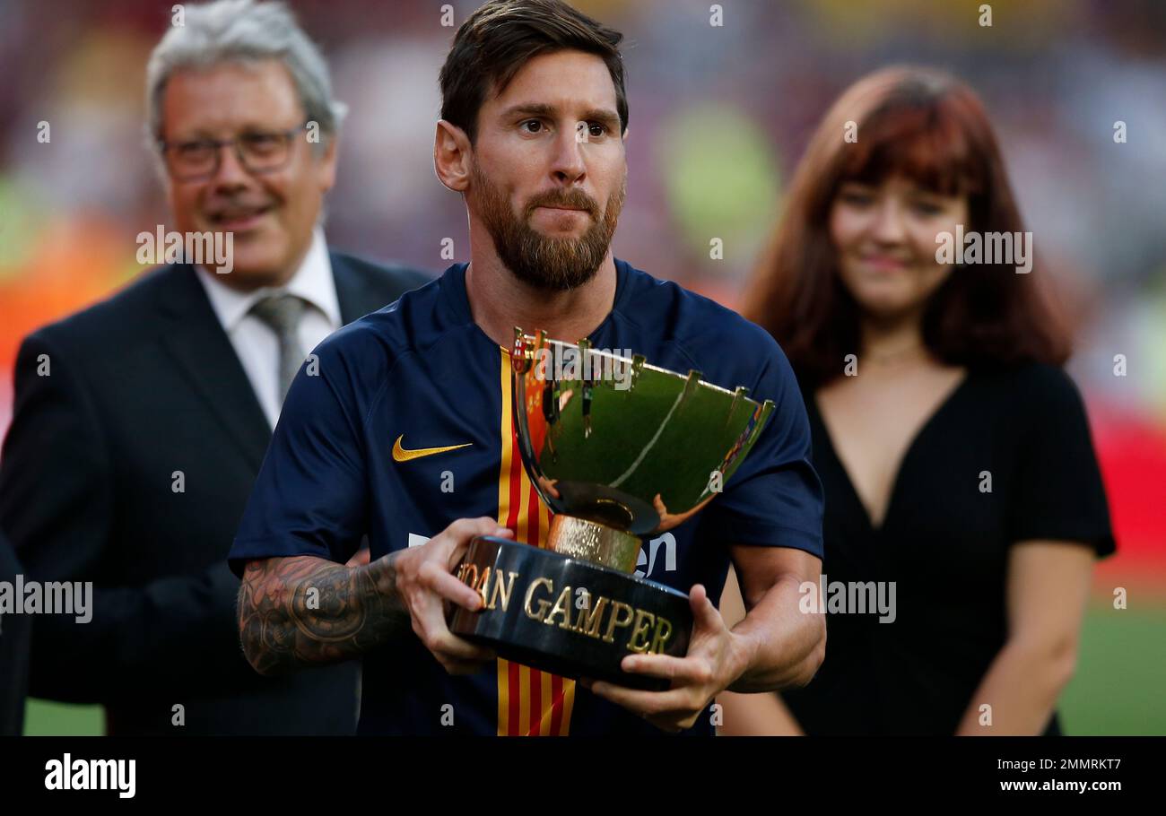 FC Barcelona's Lionel Messi holds up the Joan Gamper trophy after a ...