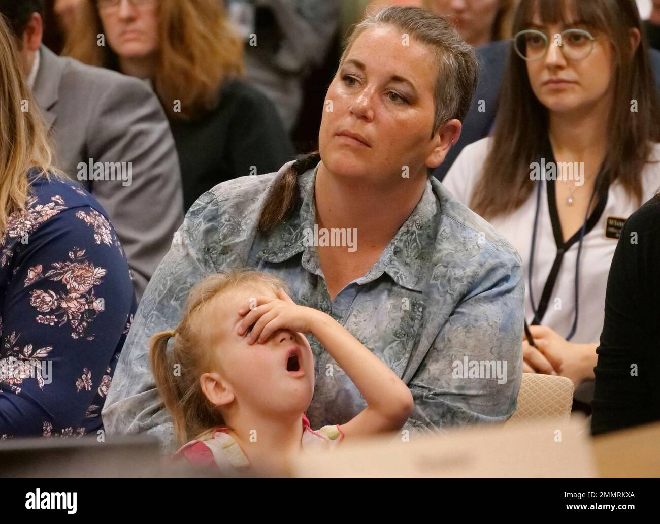 Amie Schofield and her daughter look on during a hearing at the Utah ...