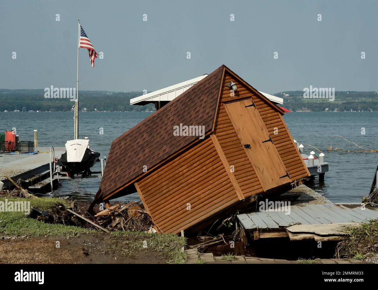 A shed displaced by massive flooding sits on a dock at Lodi Point in ...