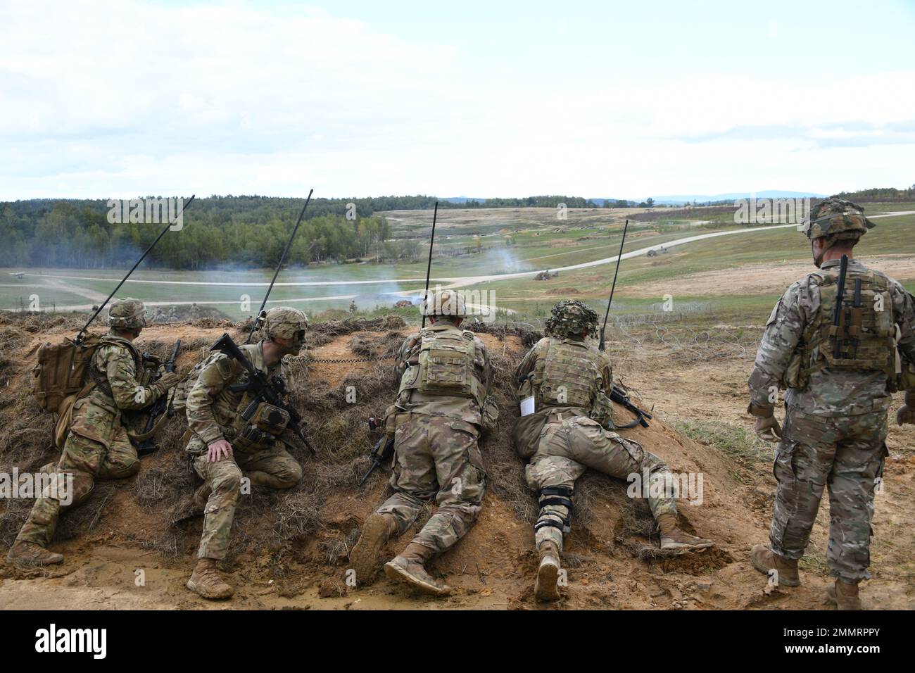 U.S. Army paratroopers assigned to 173rd Airborne Brigade Combat Team communicate movements on ...