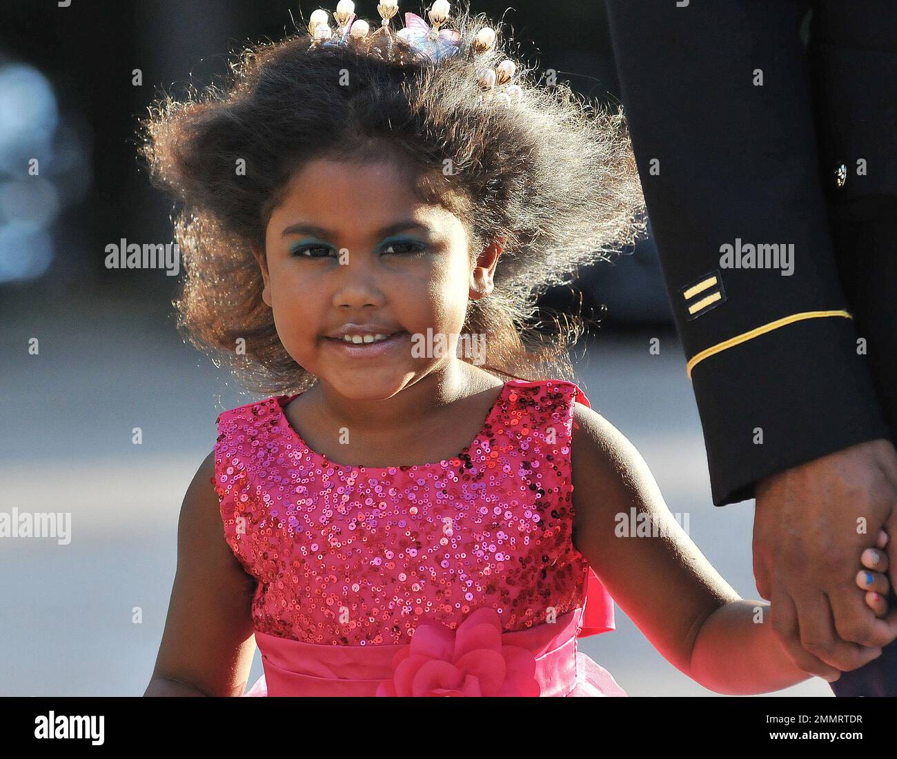 The daughter of Staff Sgt. Dakwon Menefee poses for pictures prior to ...