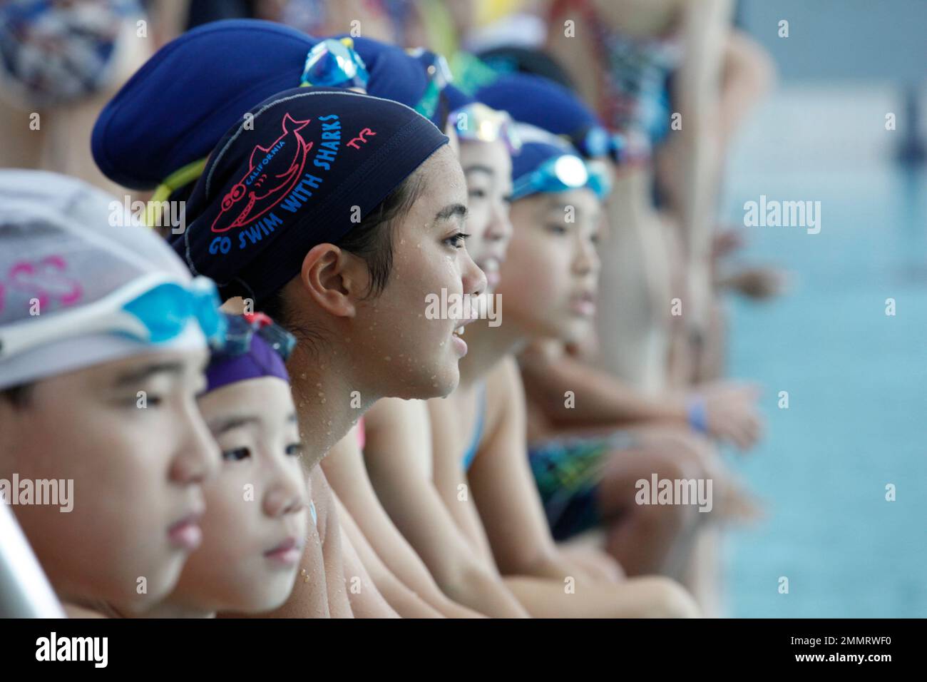 Japanese elementary and junior high school students watch a swimming ...