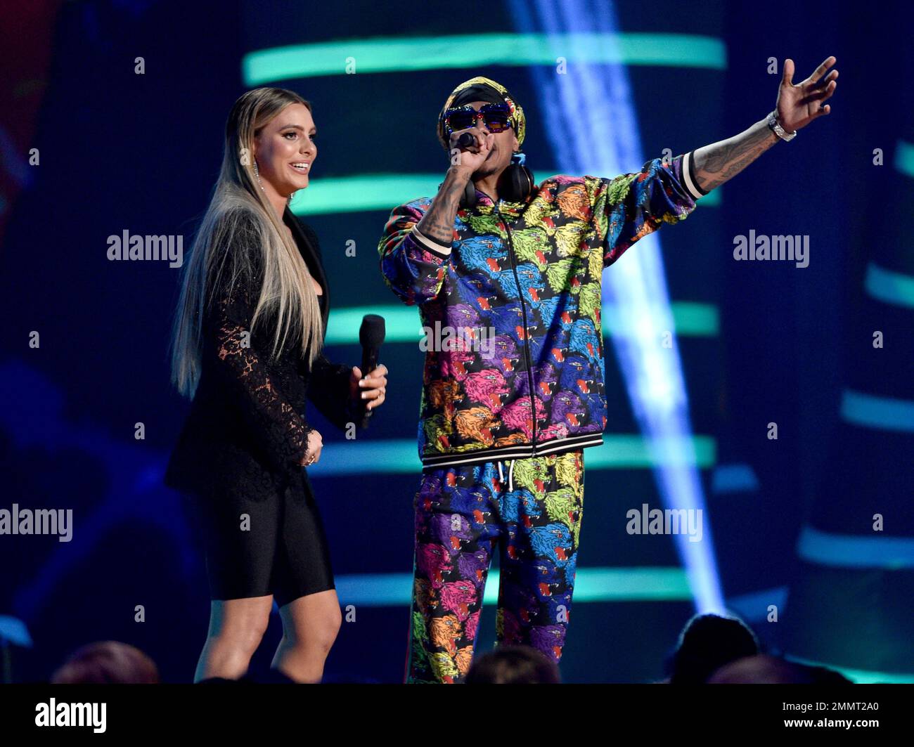 Hosts Lele Pons, left, and Nick Cannon speak at the Teen Choice Awards ...