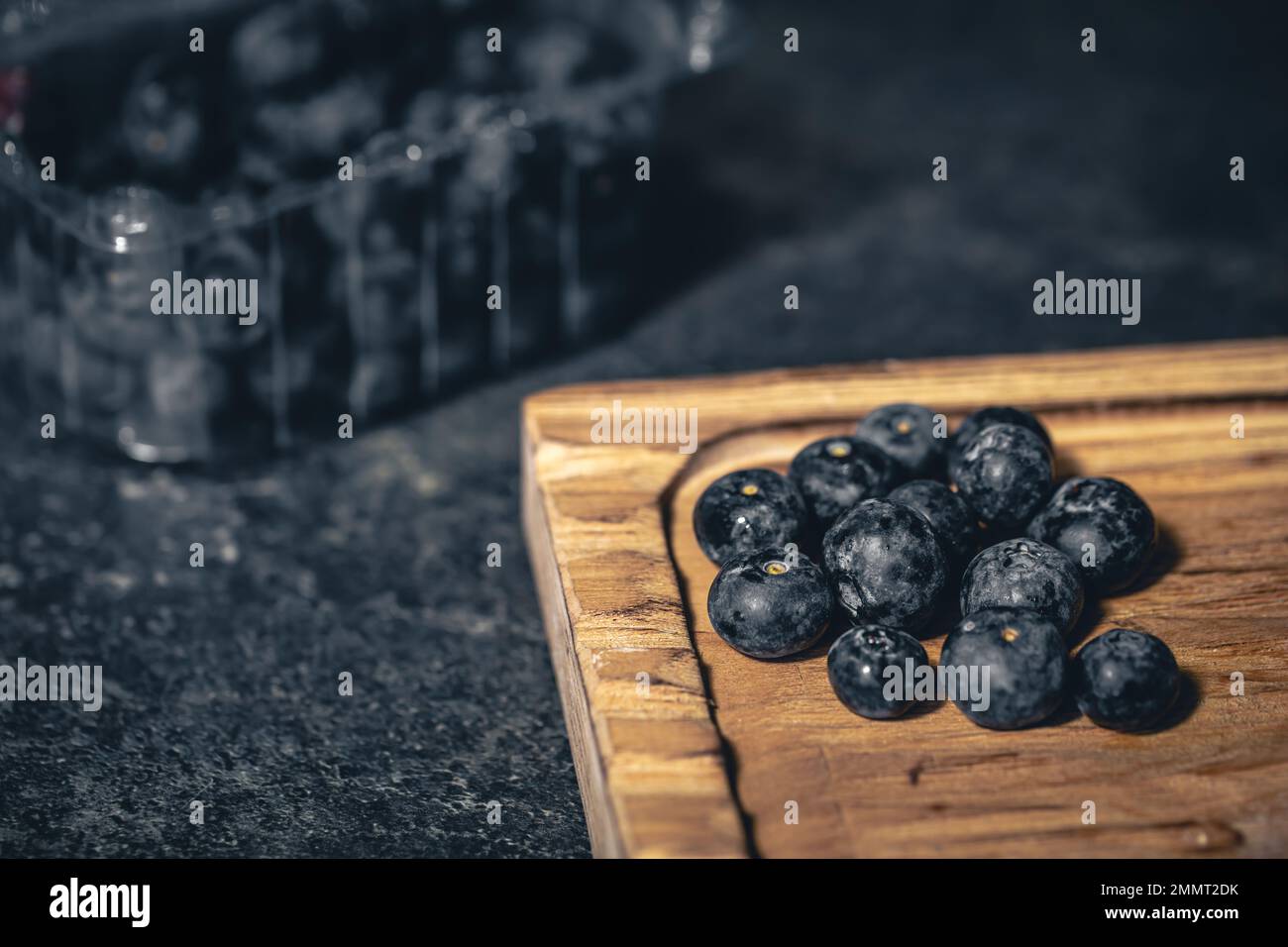 Blueberry berries close-up on a dark blurred background Stock Photo - Alamy