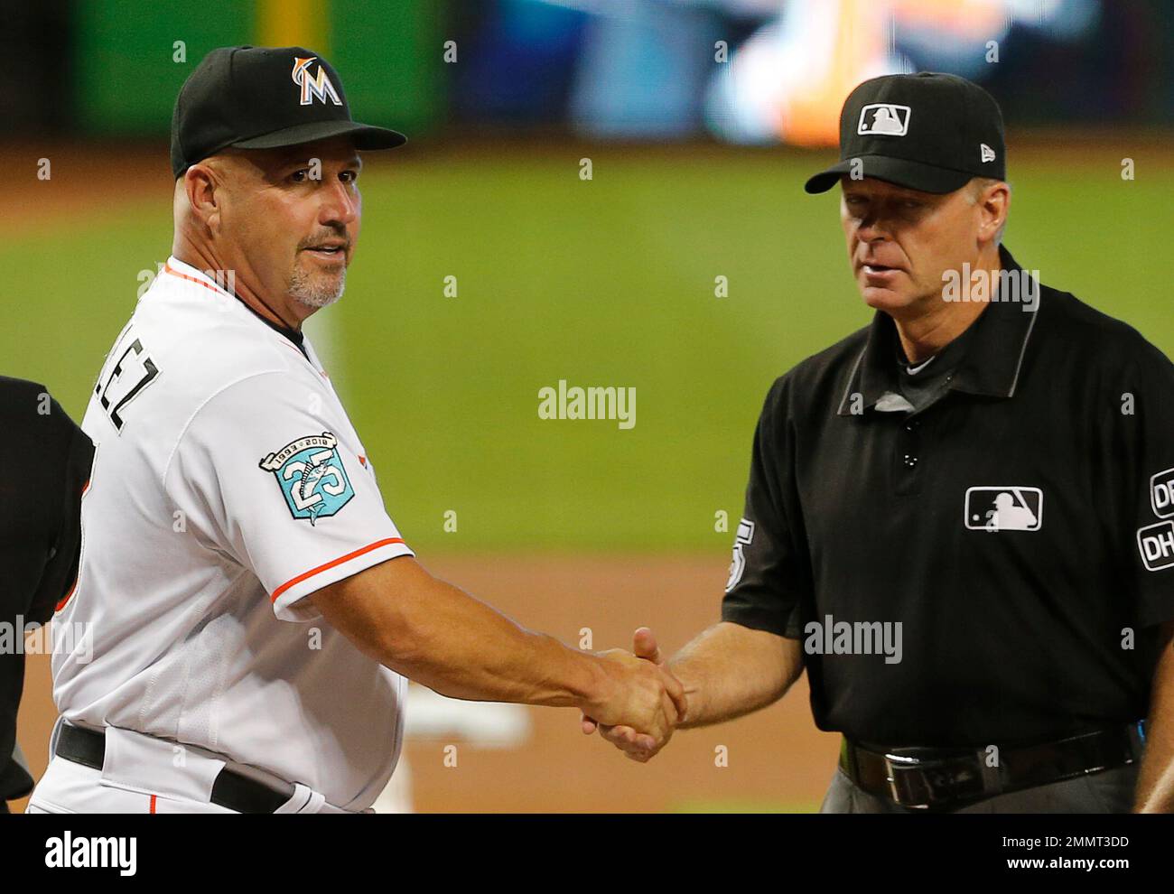 Miami Marlins third base coach Fredi Gonzalez, left, speaks with umpire ...