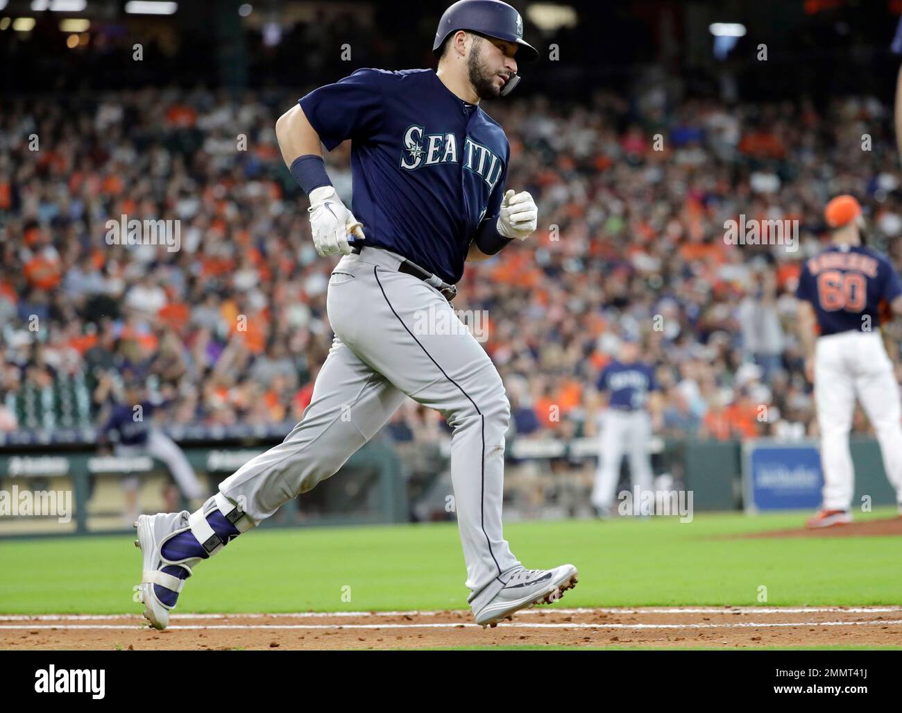 Seattle Mariners' Mike Zunino runs the bases after hitting a home run ...