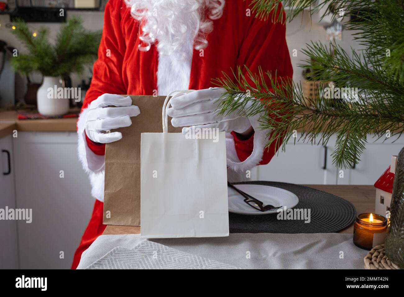 Santa Claus puts it on kitchen table and takes away paper bags with ...
