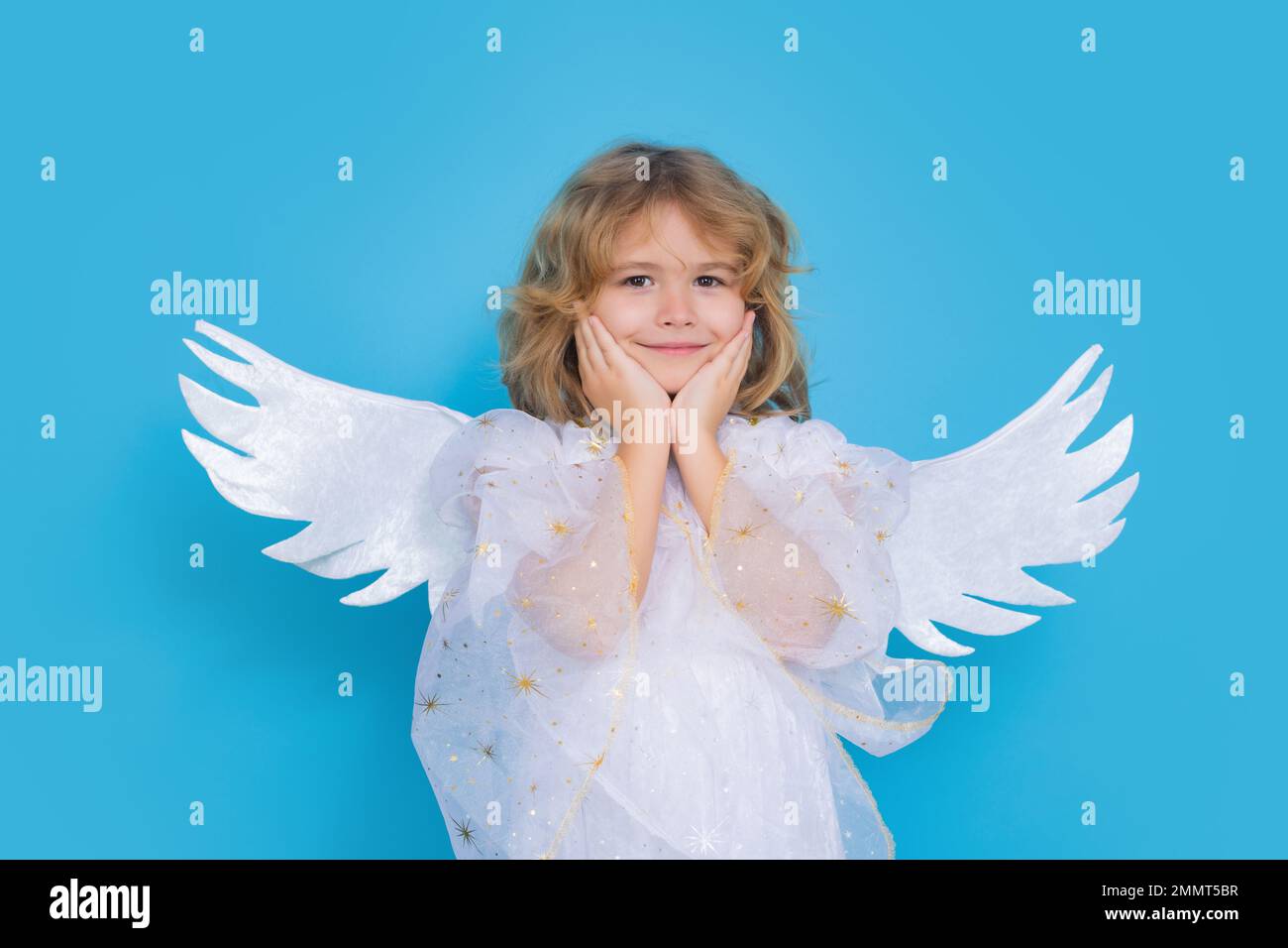 Kid wearing angel costume white dress and feather wings. Innocent child ...