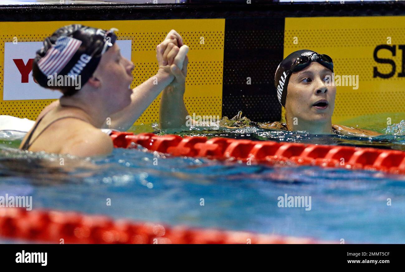 U.S. swimmer Micah Sumrall, right, checks her time with her compatriot ...
