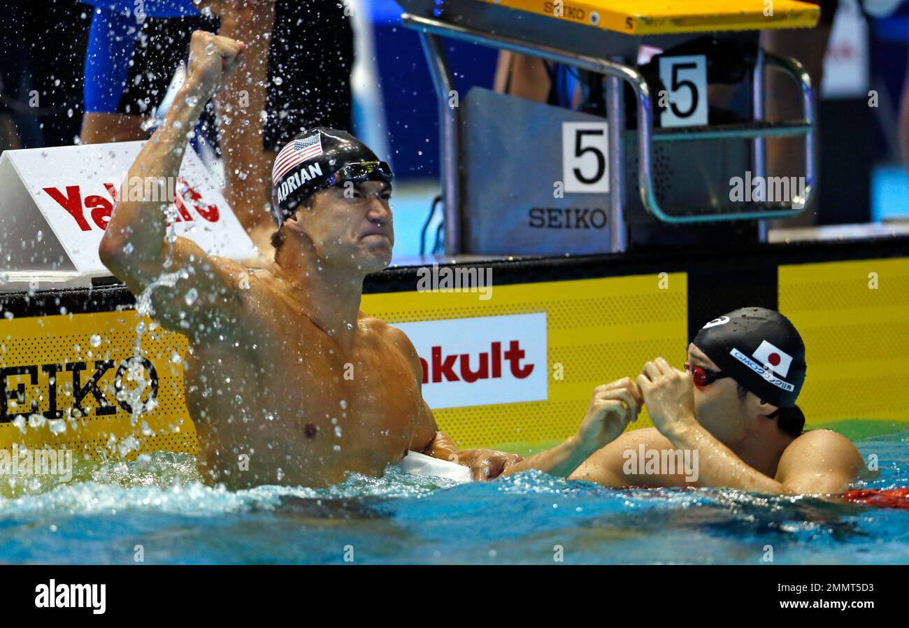 U.S. swimmer Nathan Adrian, left, reacts after U.S. team won the men's ...
