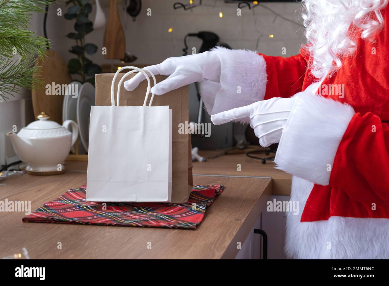 Santa Claus puts it on kitchen table and takes away paper bags with ...