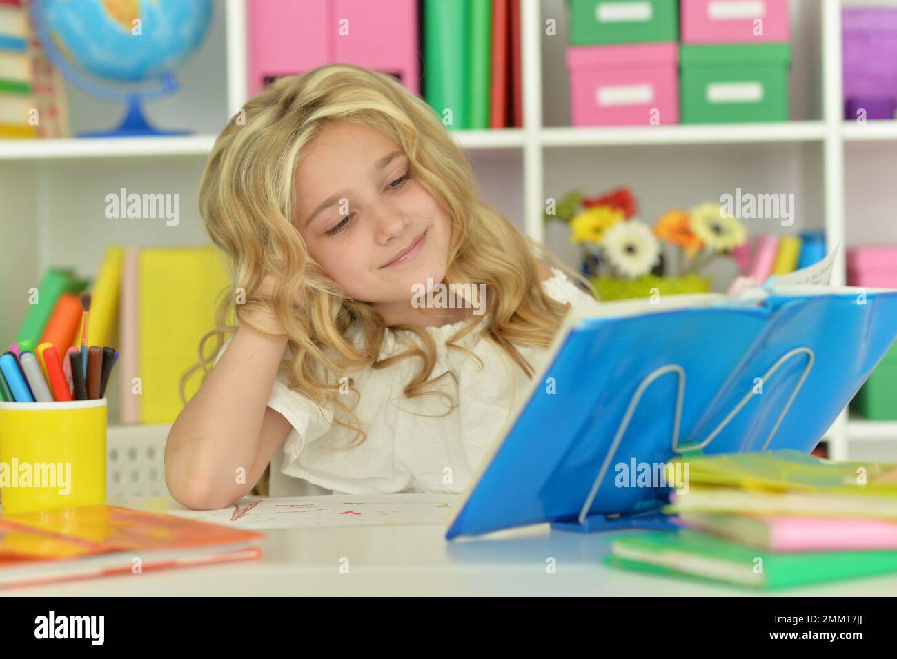 little girl studying at home at the table Stock Photo - Alamy