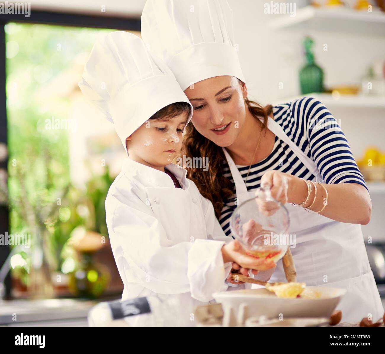Bake it yourself. a mother and her son baking in the kitchen Stock ...