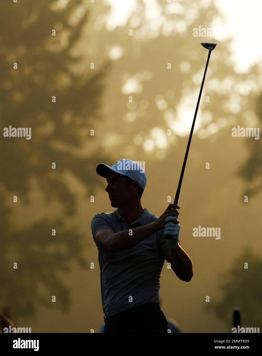 Ross Fisher, of England watches his tee shot on the seventh hole during ...