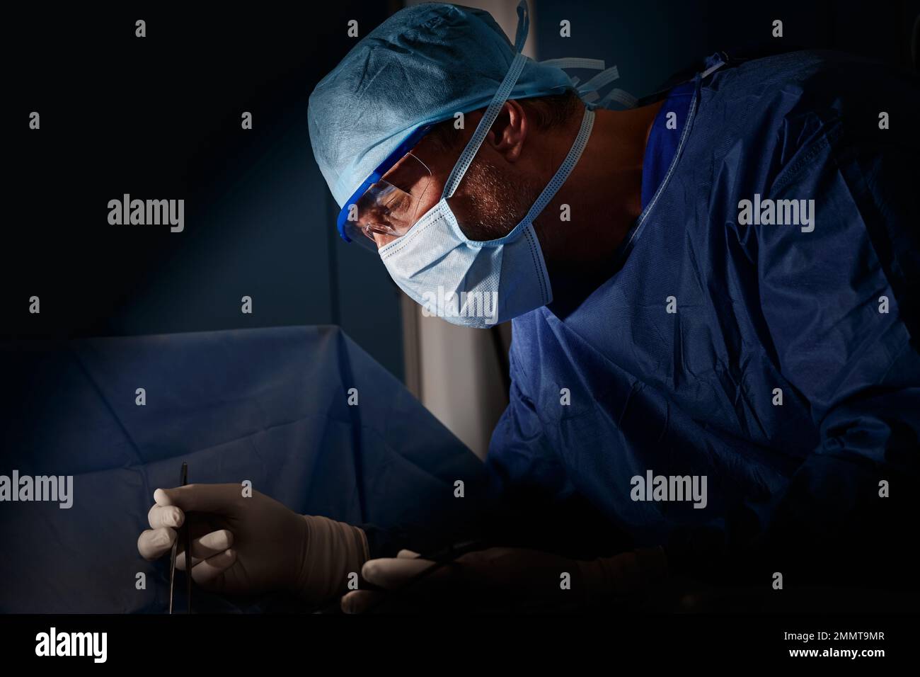 Surgeon concentrating on patient during surgery at hospital Stock Photo ...