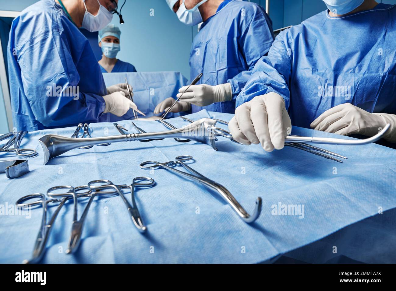 Surgical Team. Surgical nurse giving surgical scissors to male surgeon ...