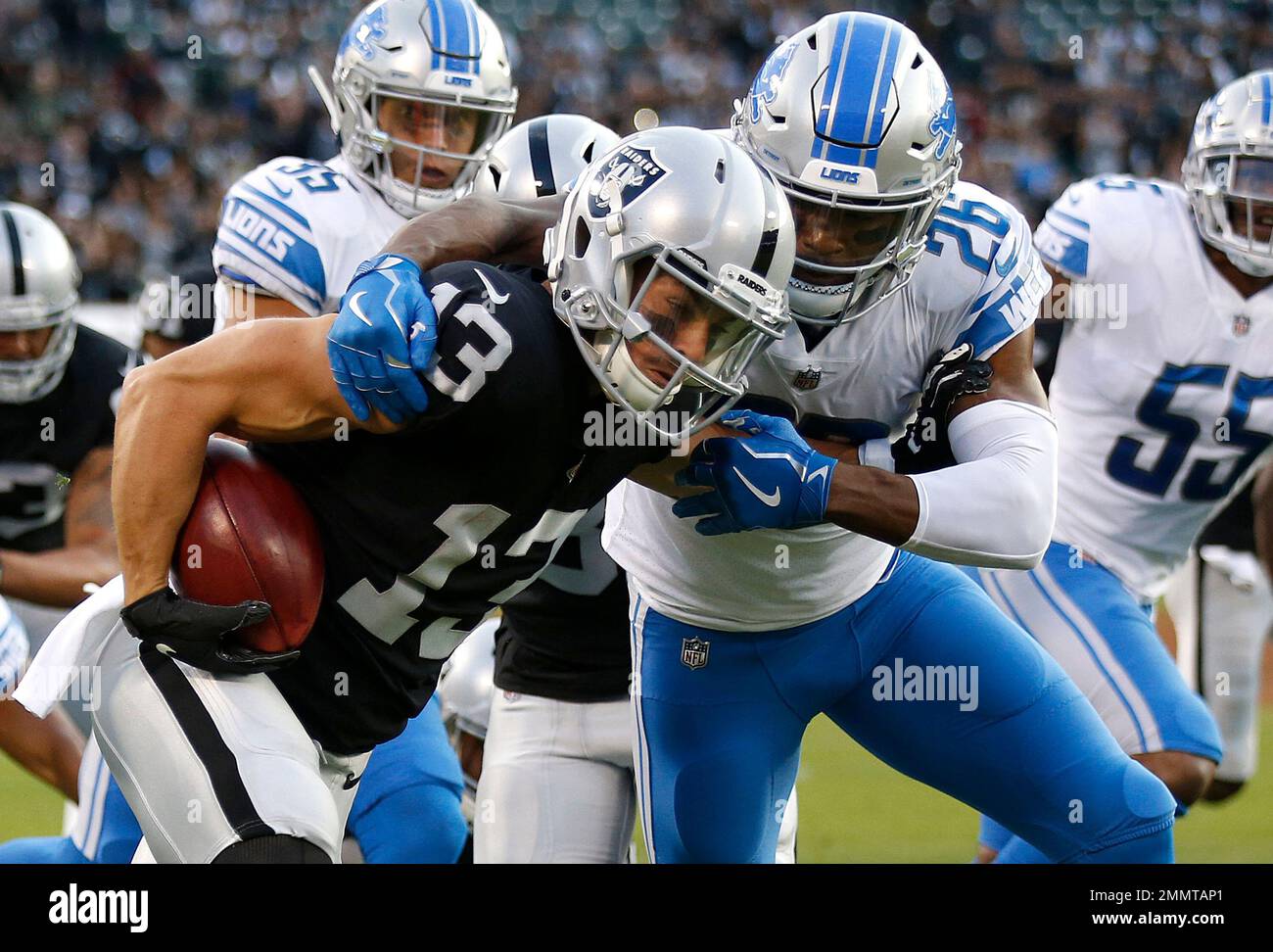 Oakland Raiders' Griff Whalen is tackled by Detroit Lions' DeShawn ...