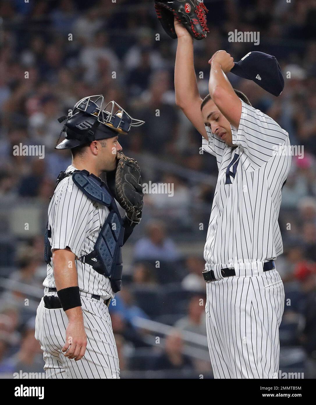 New York Yankees catcher Austin Romine, left, talks on the mound with ...
