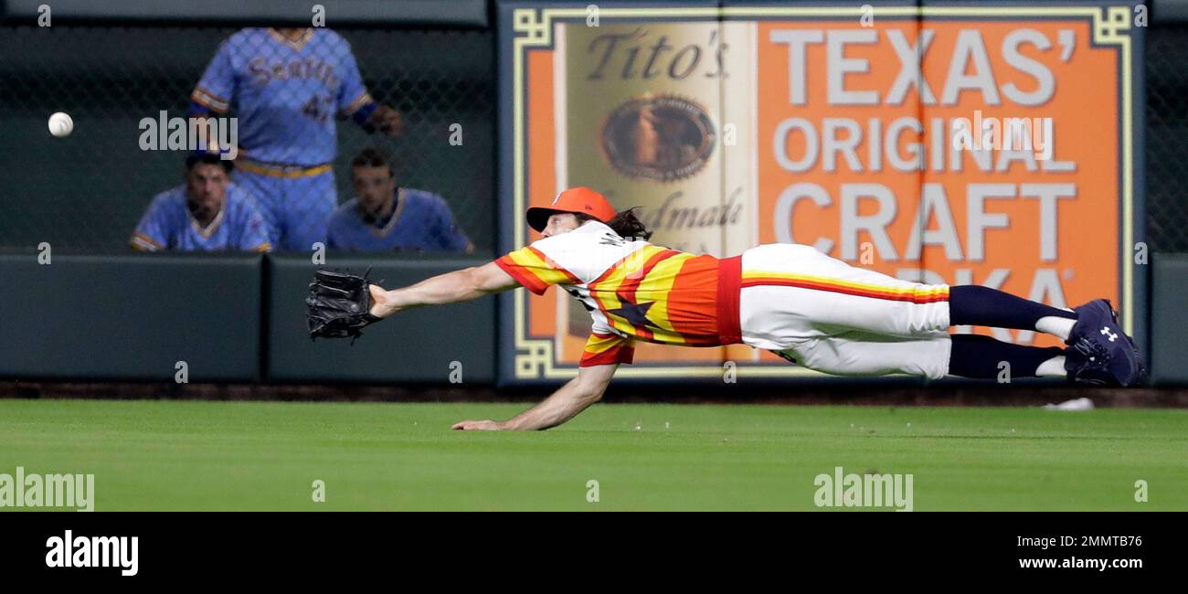 Houston Astros center fielder Jake Marisnick dives and makes the catch ...