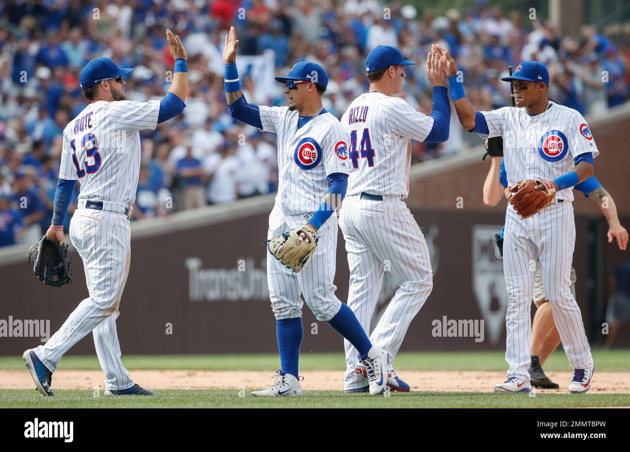 Chicago Cubs' players David Bote, left, Javier Baez, second left ...