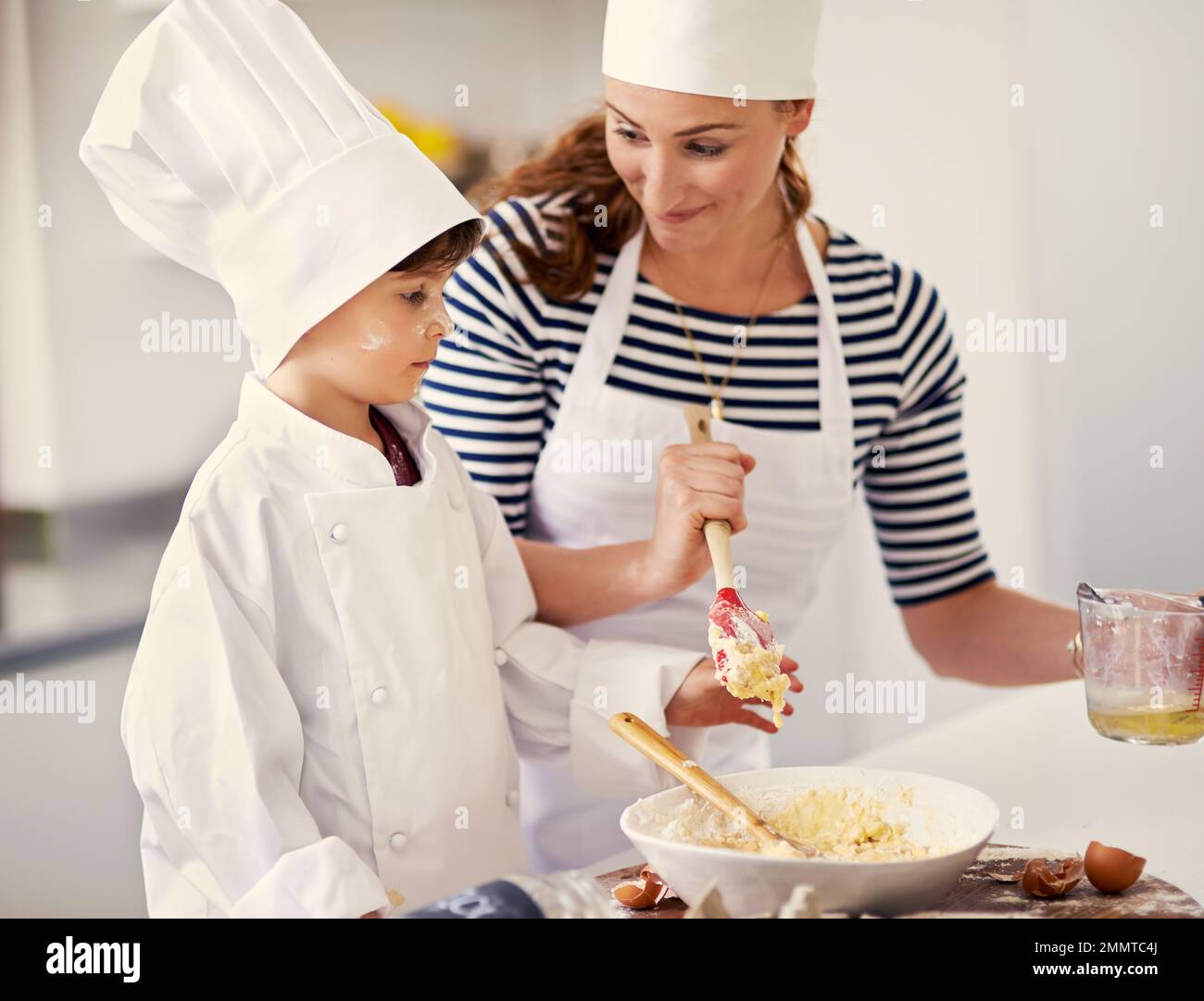 When all else fails, bake a cake. a mother and her son baking in the ...