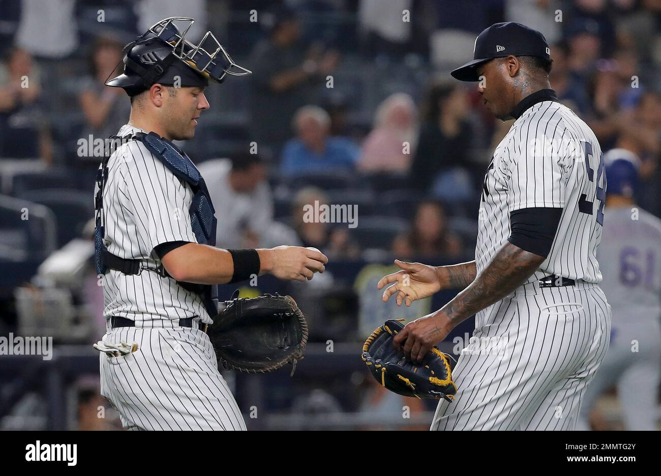 New York Yankees catcher Austin Romine, left, hands the game ball to ...
