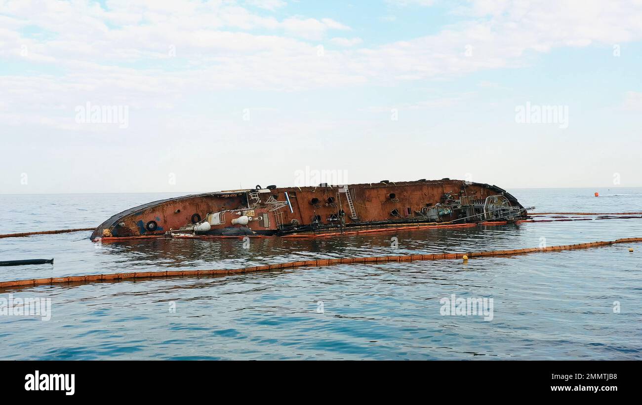 Sunken drowned tanker ship near the aground. Broken rusty ship on the ...