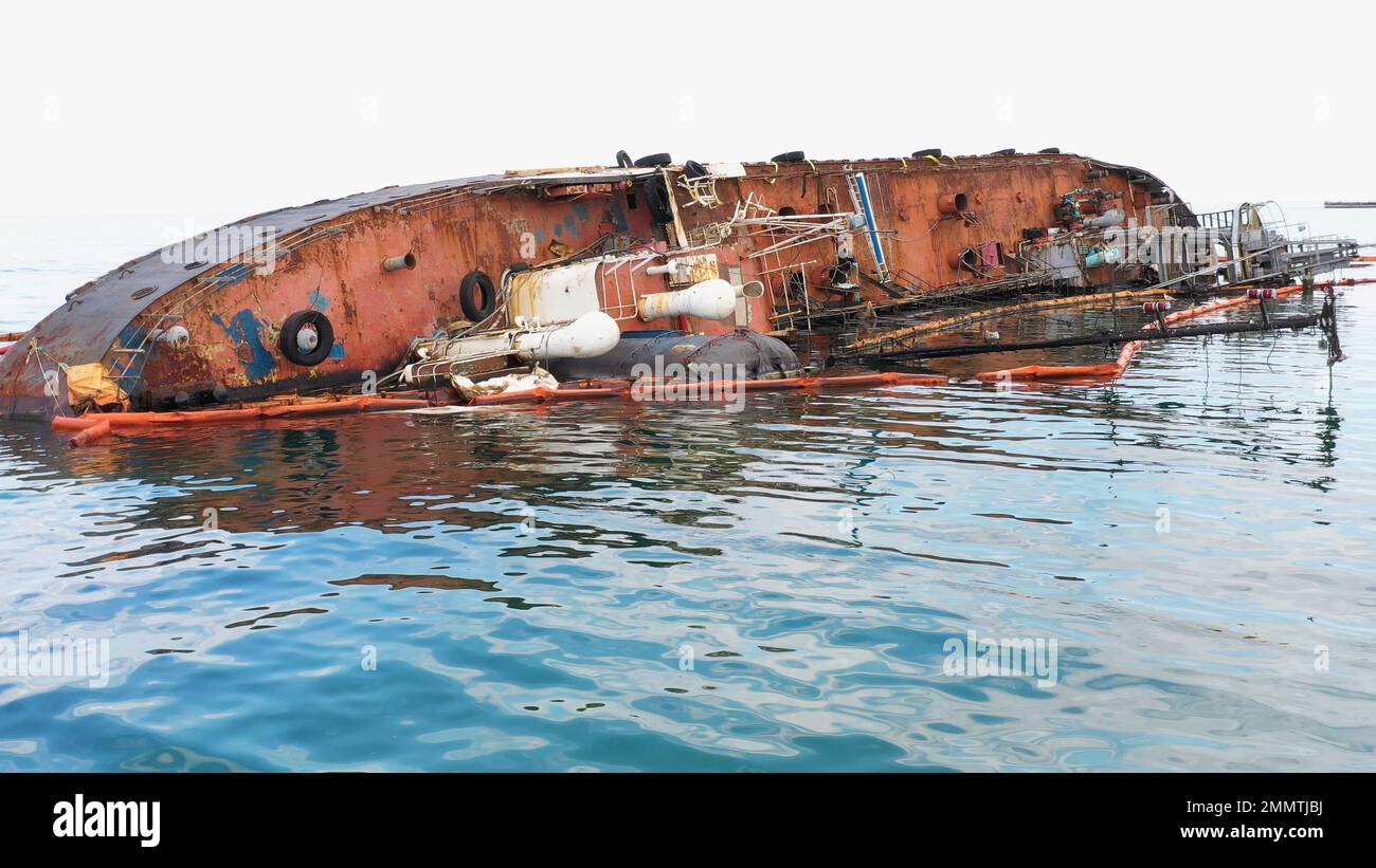 Broken rusty oil tanker ship in the shallow water. Sunken drowned ship ...