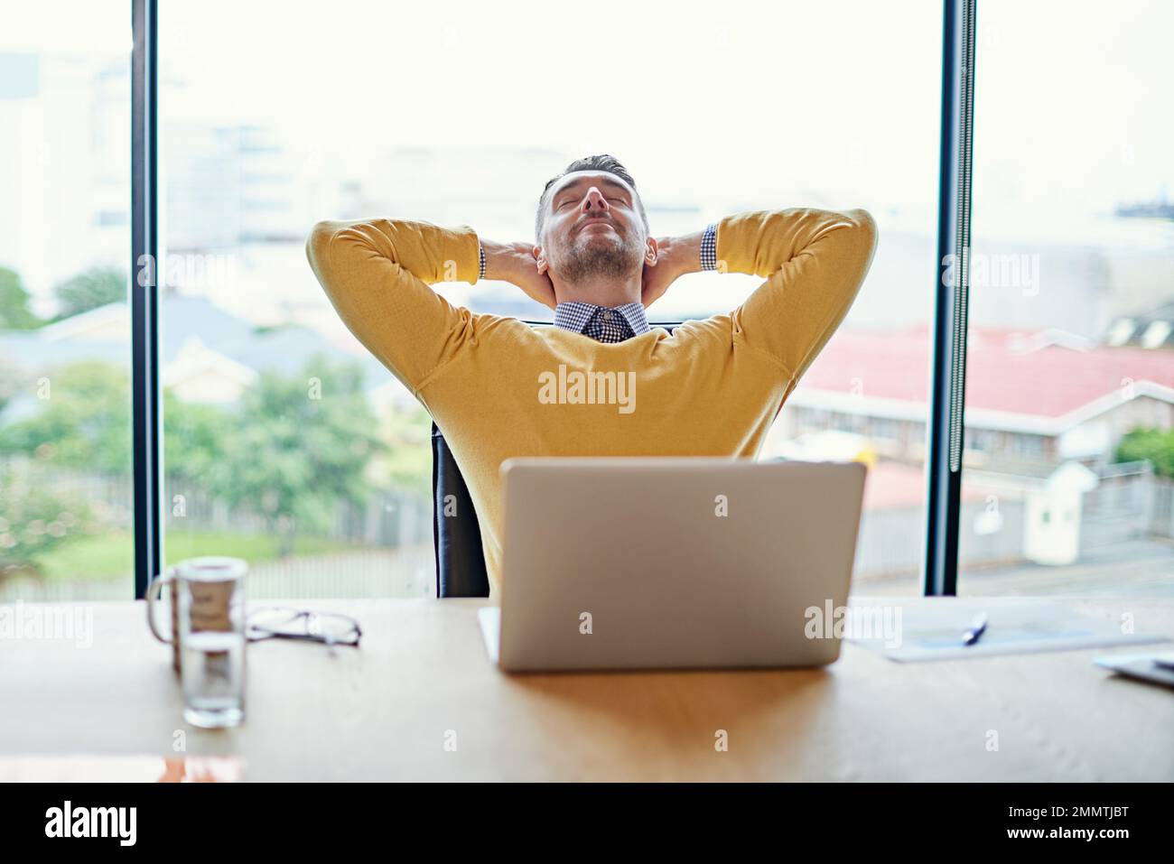 Give yourself a break. a businessman working on his laptop at his desk ...