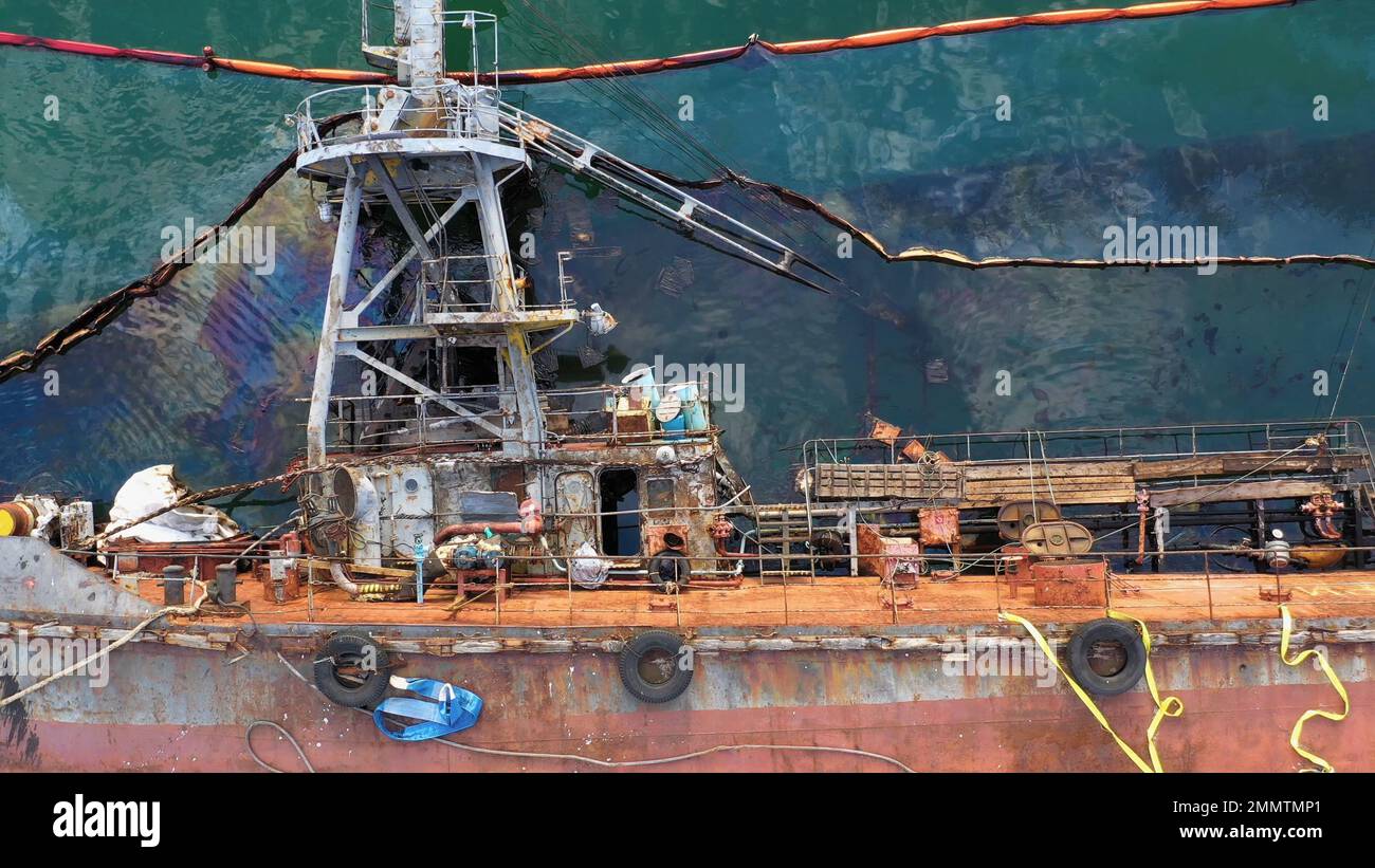 Top view drowned sunken overturned tanker ship on its edge in the ...