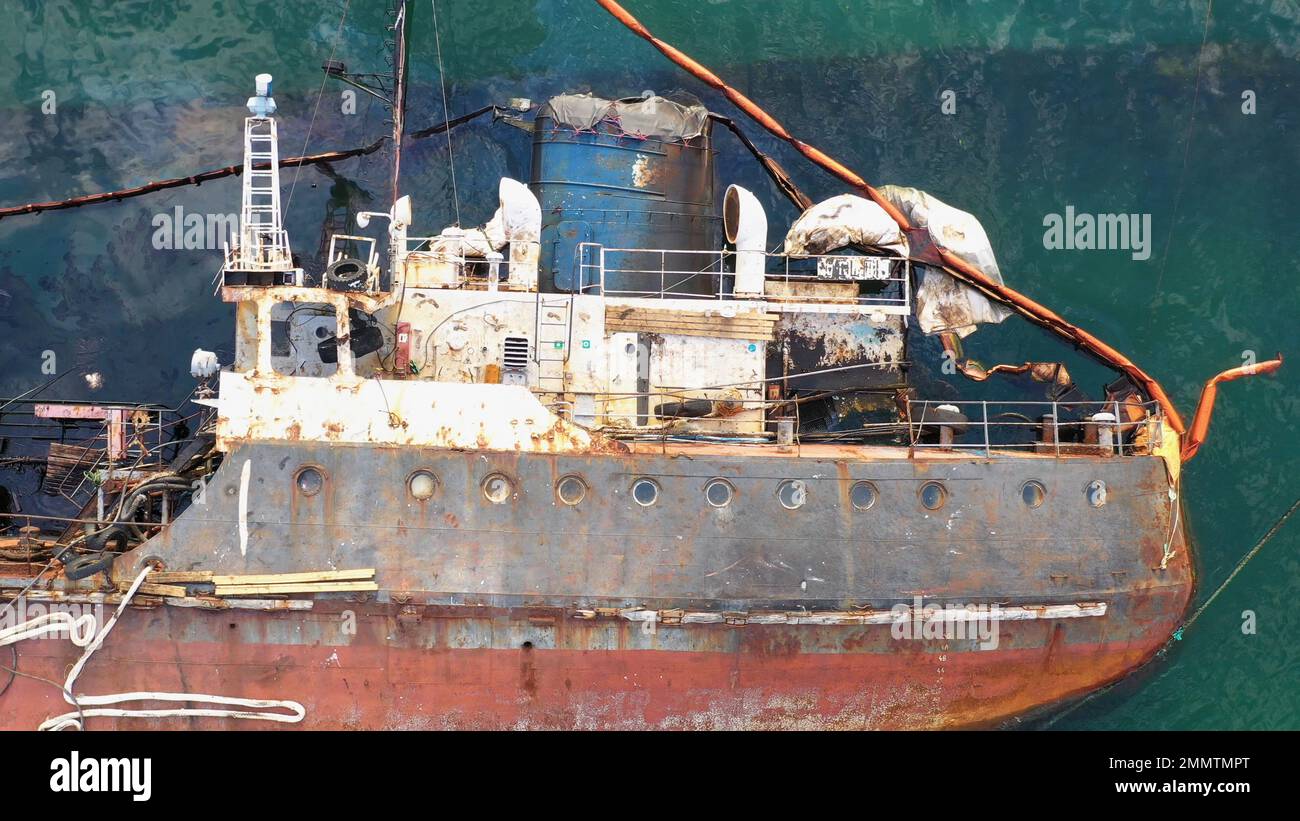 Aerial top view of overturned broken rusty oil tanker ship after the ...