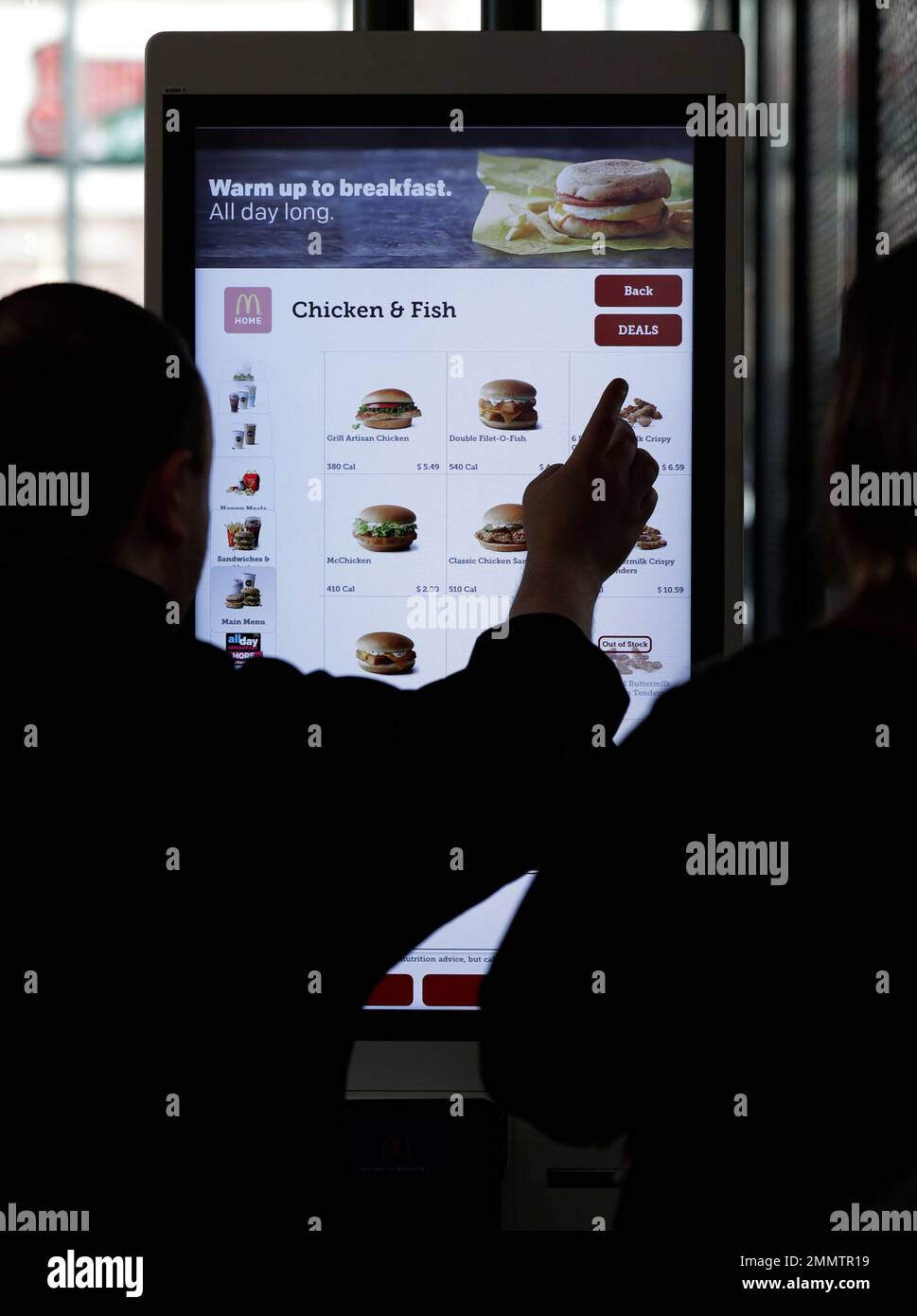 People look at an electronic ordering menu at McDonald's Chicago ...