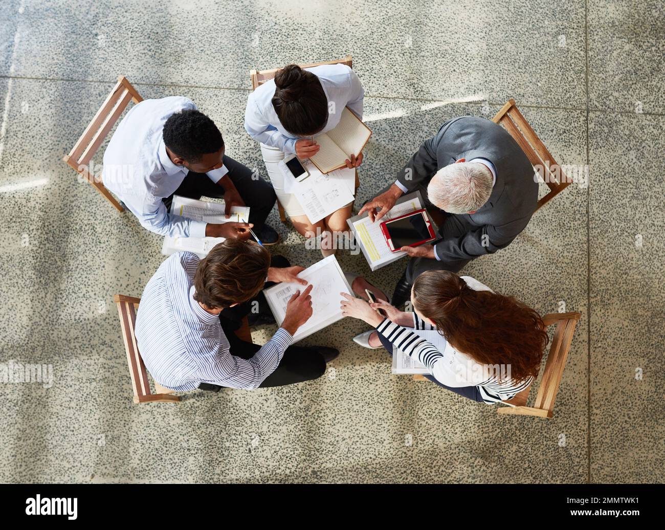 Putting their heads together. High angle shot of a group of ...