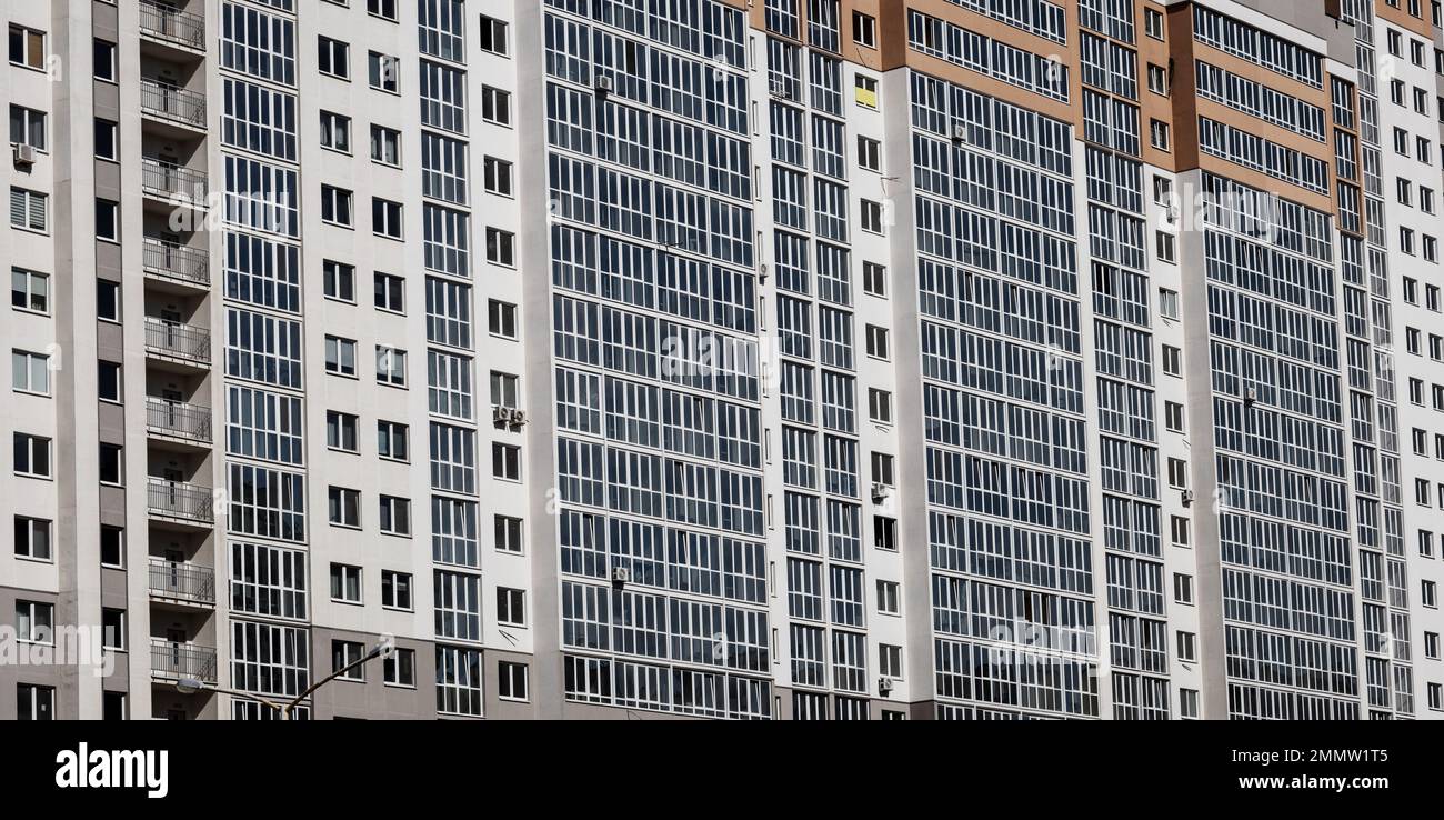 many windows and balconies on the facade of an apartment building ...
