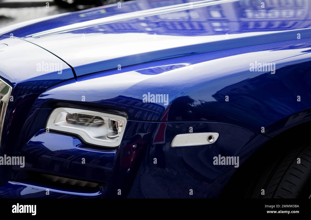 front headlight of a prestigious blue car. Modern bright automobile ...