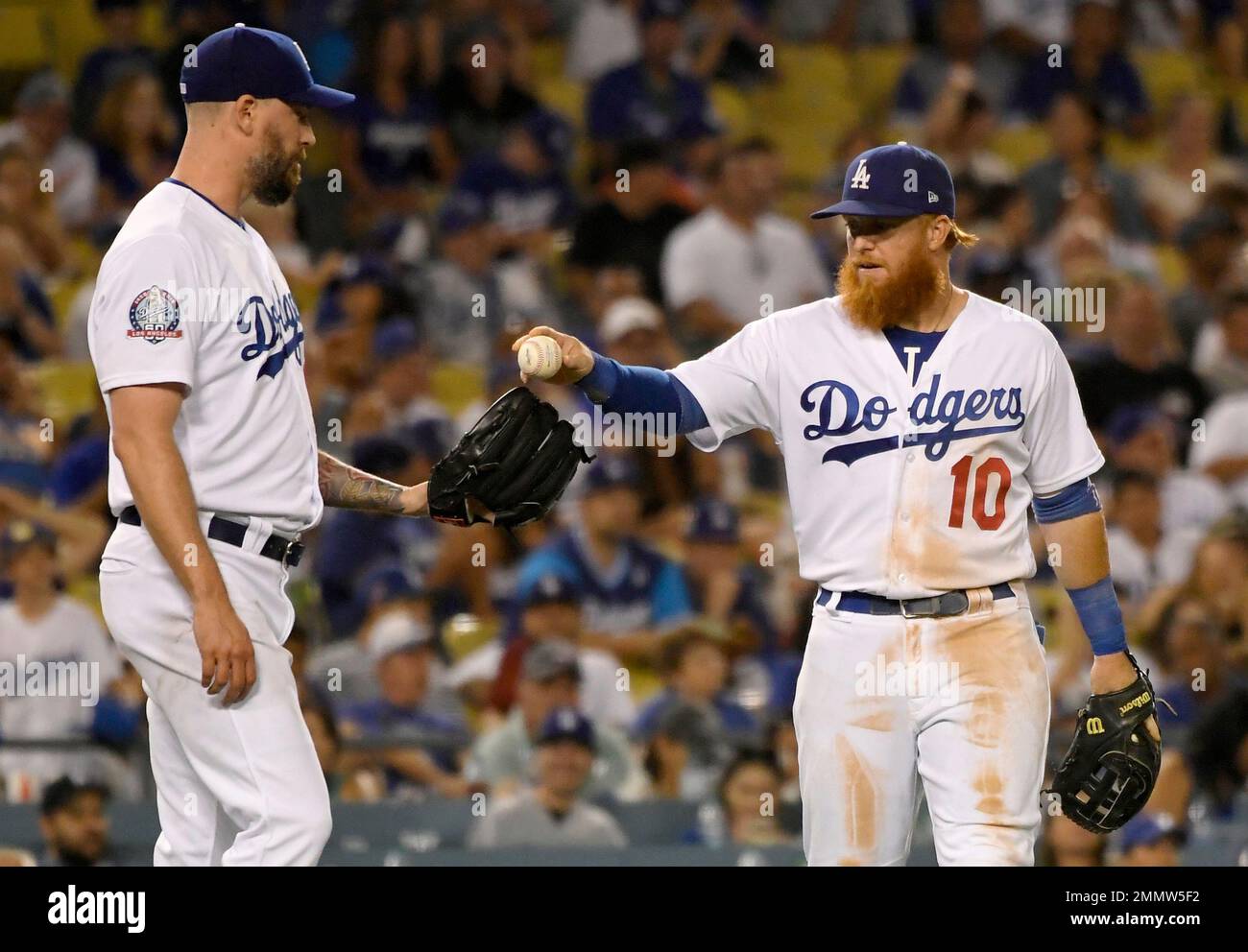 Los Angeles Dodgers relief pitcher John Axford (88) gets the ball from ...