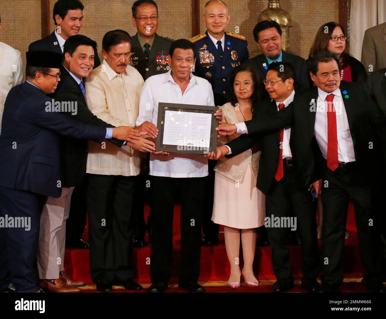 President Rodrigo Duterte, center, and leaders of the Moro Islamic ...