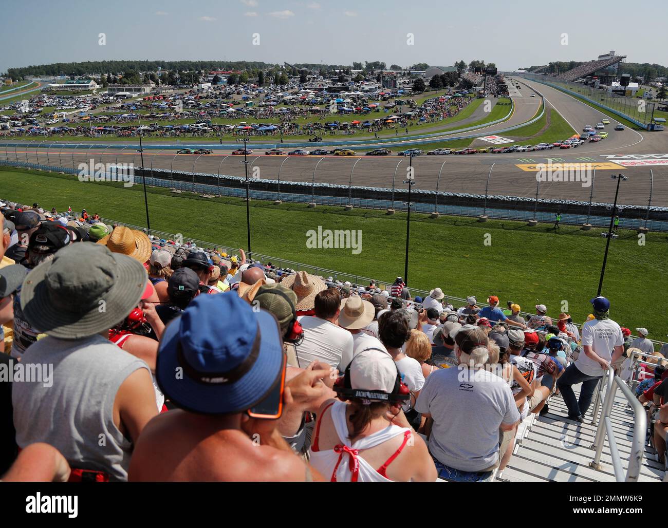 Spectators watch as drivers come around turn one during a restart after ...
