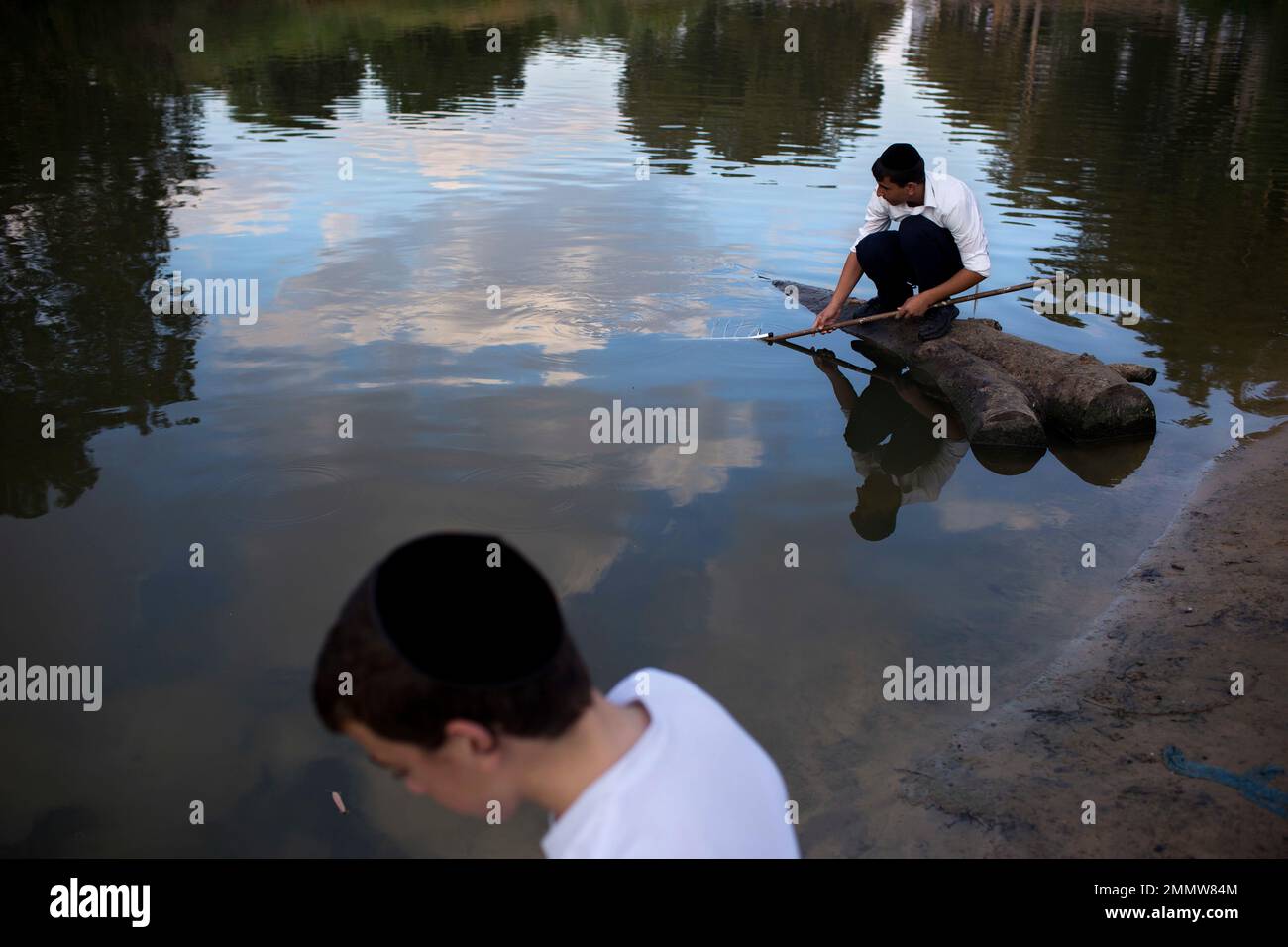 Ultra-Orthodox Jewish youths try to catch fish during summer vacation ...