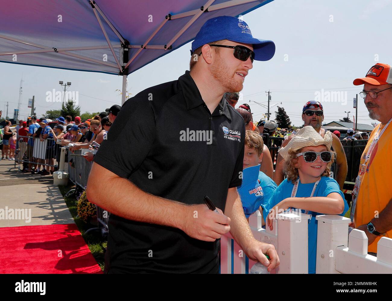 Chris Buescher signs autographs for fans before a NASCAR Cup series ...