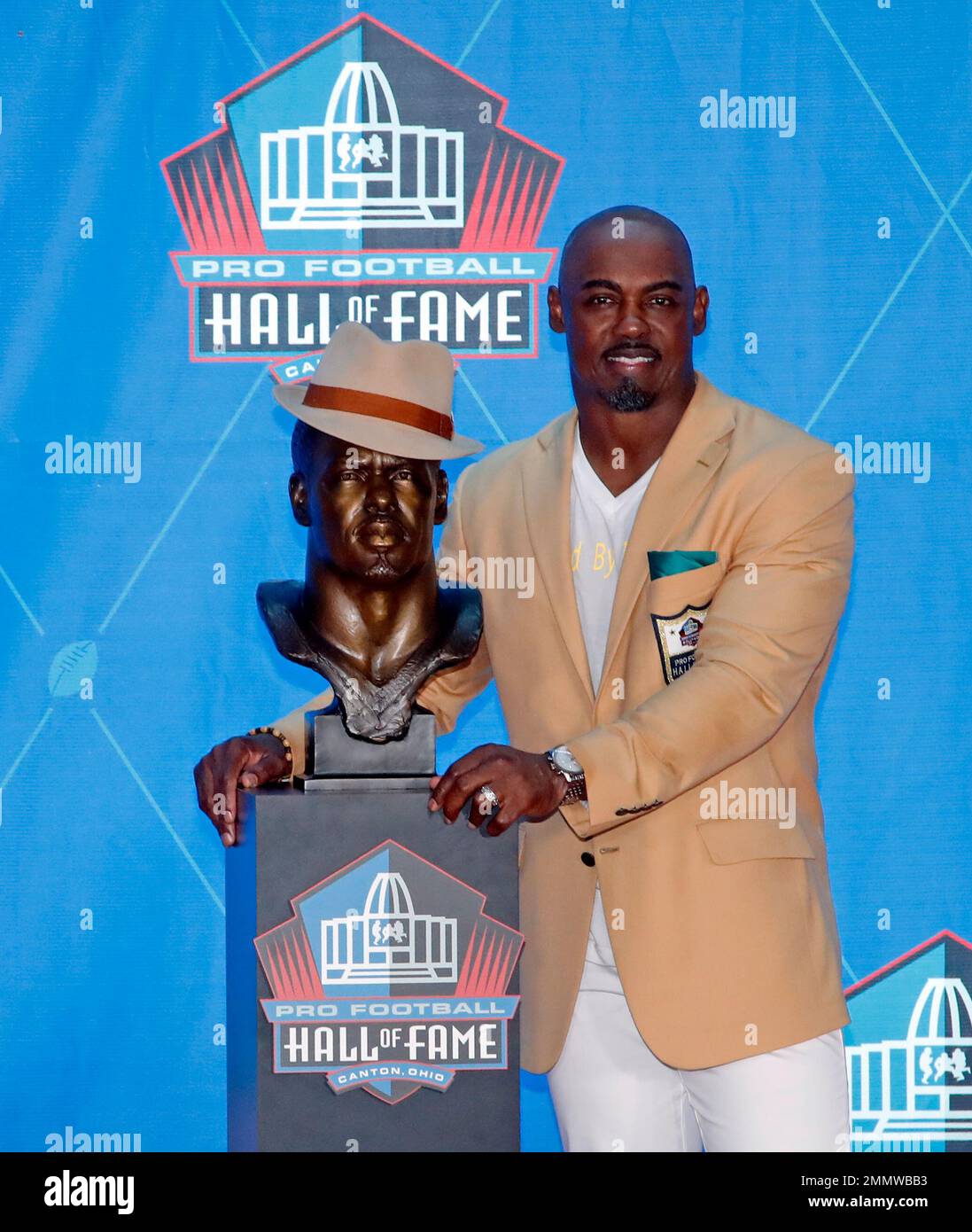 Former NFL player Brian Dawkins poses with a bust of himself during an ...