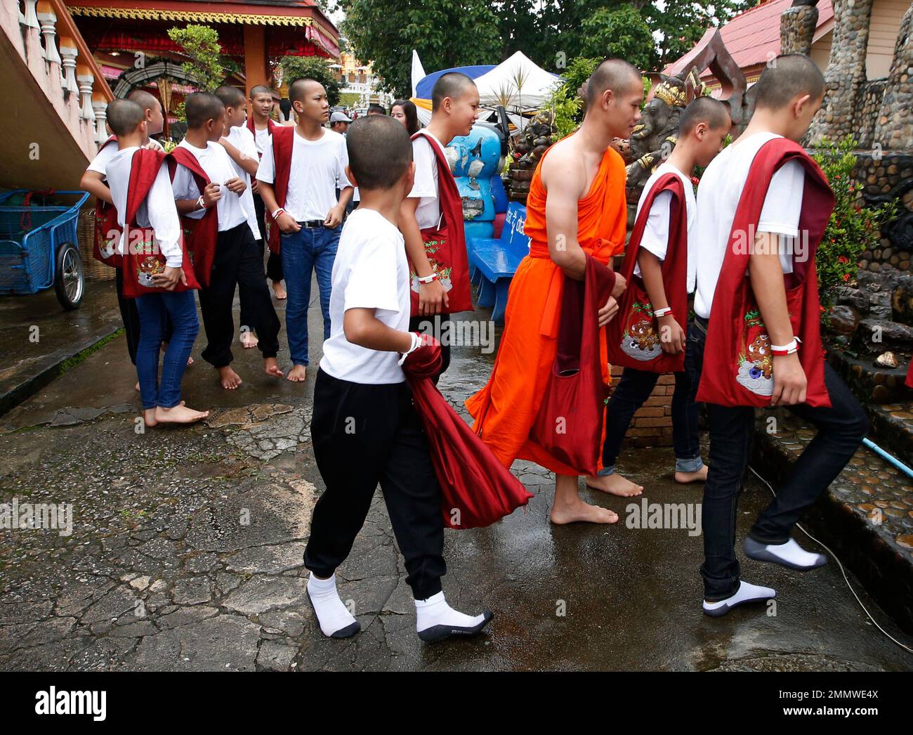 Members of Wild Boars soccer team walk with Thai Buddhist monk, former ...