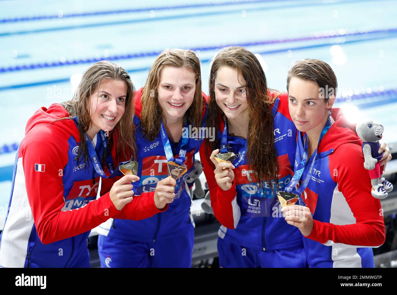 The French team poses with their gold medals for the 4 X 100 meters ...