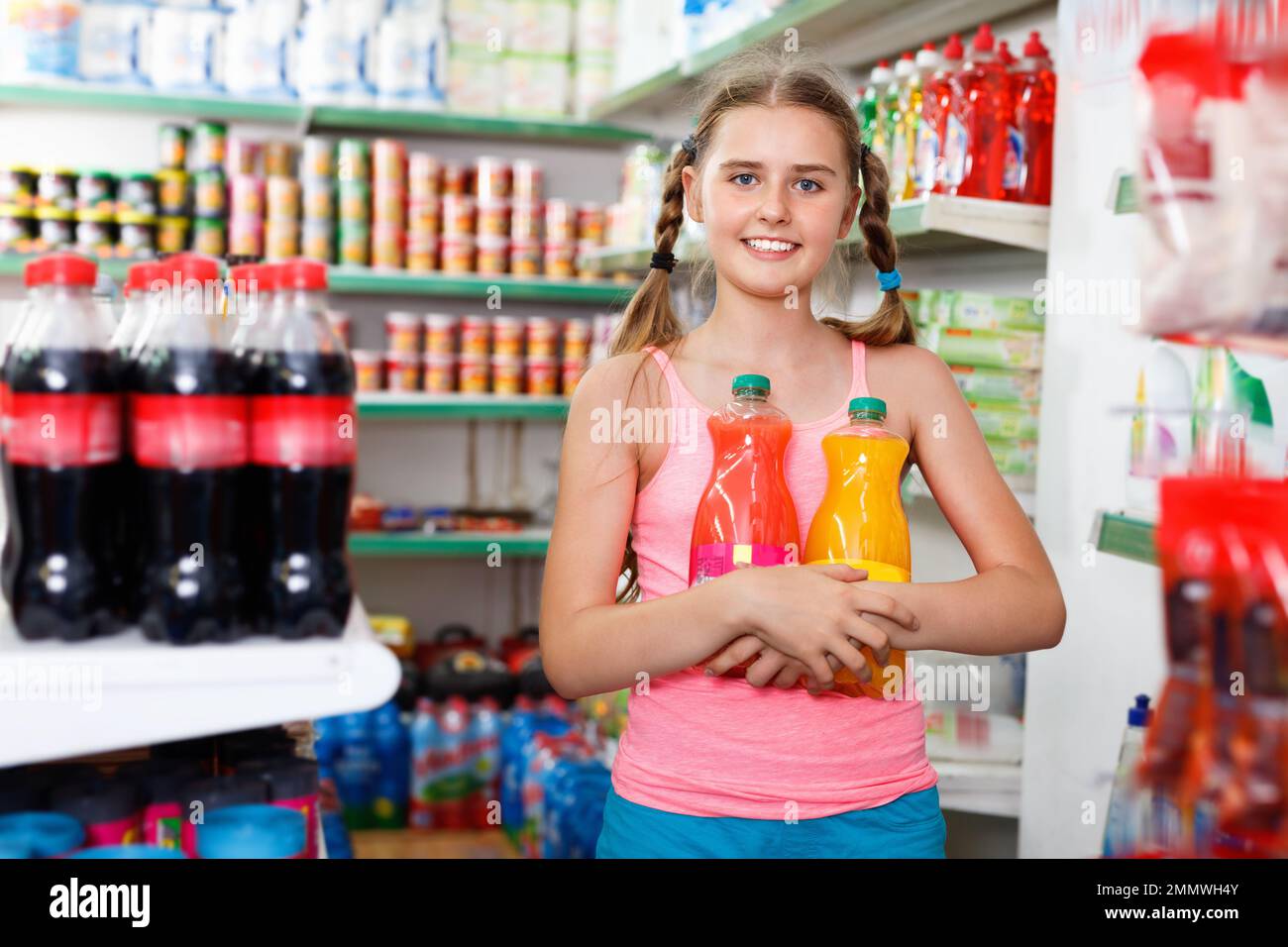 Tween girl choosing and buying food products at grocery shop Stock ...