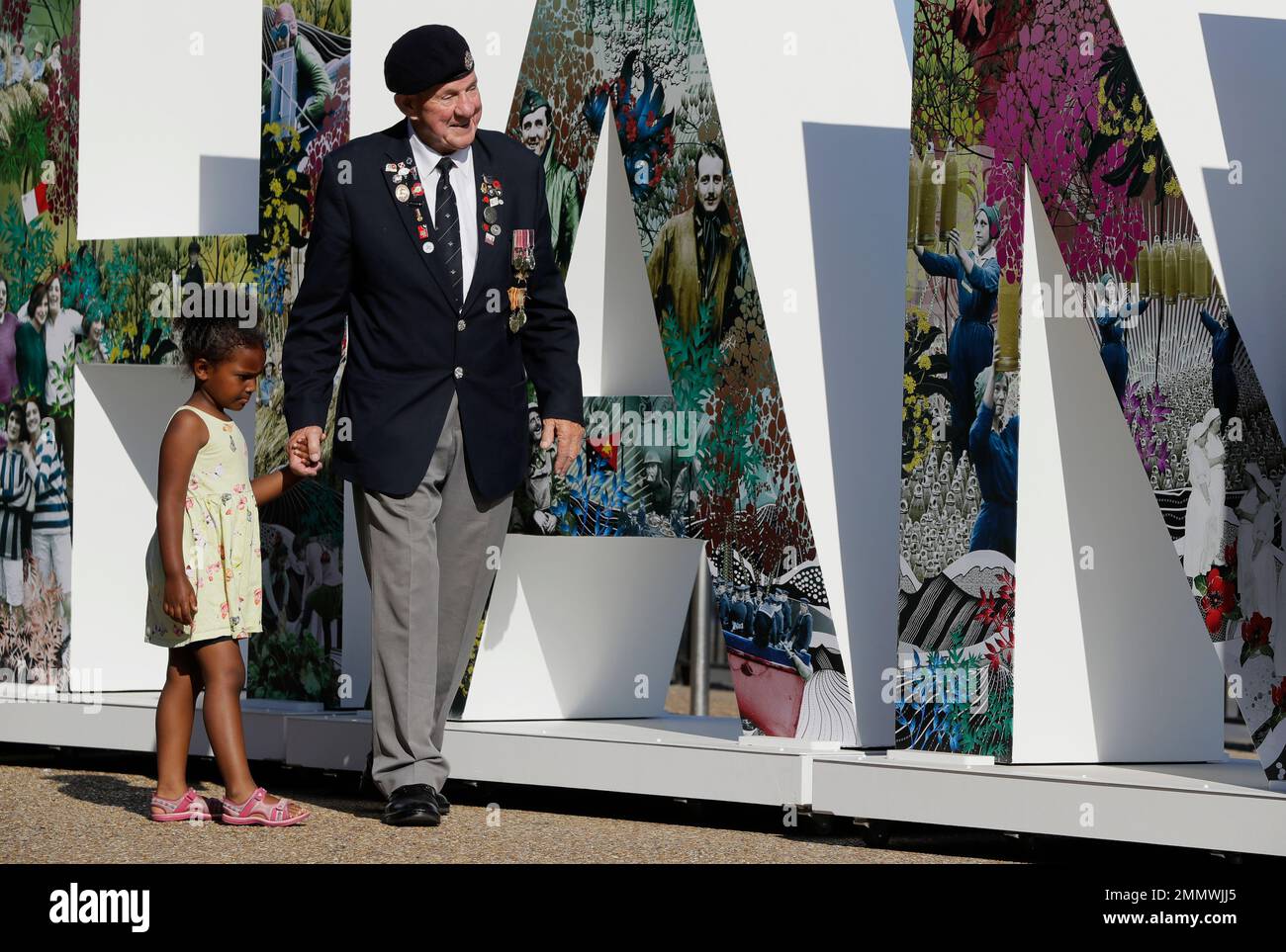 RAF veteran Tom Weatherall, 84, walks with Maraki Tewdros, 5, as he ...