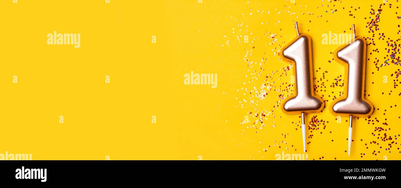 Gold candles in the form of number eleven Stock Photo - Alamy