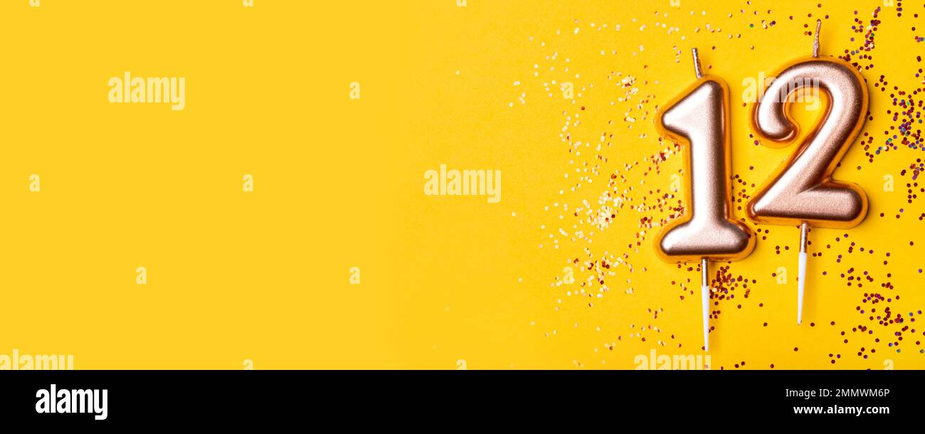 Gold candles in the form of number twelve Stock Photo - Alamy